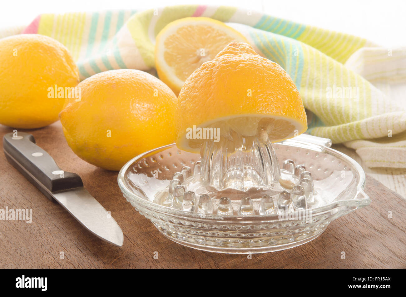 half a lemon is squeezed on a lemon squeezer Stock Photo - Alamy