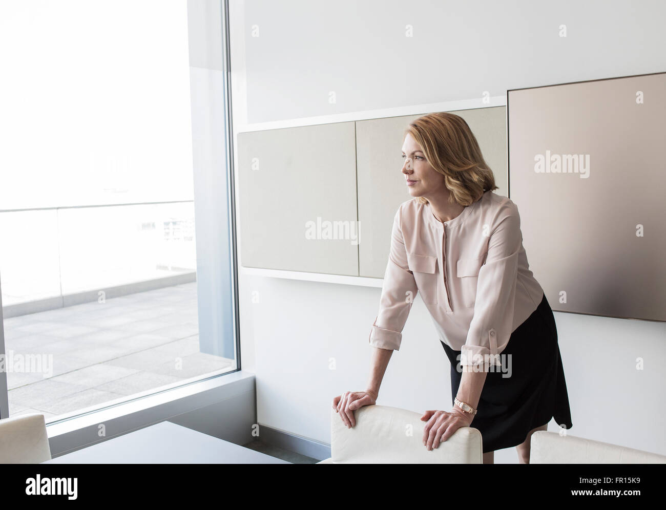Pensive businesswoman looking out office window Stock Photo - Alamy Pensive businesswoman looking out office window Stock Photo - Alamy
