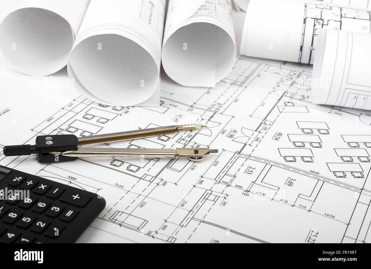 Rolls of blueprints with divider and calculator. Building concept Stock ...