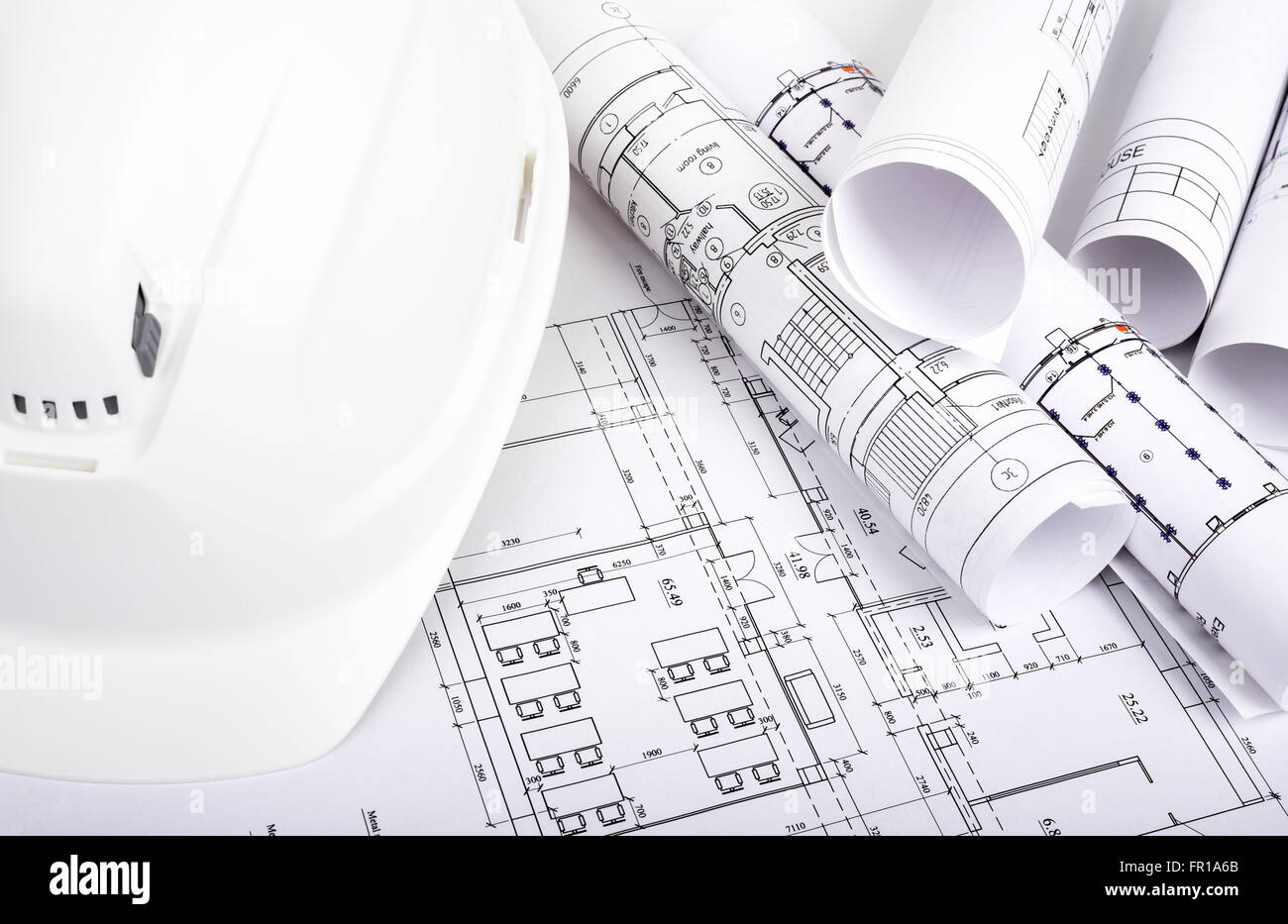 Architecture plan and rolls of blueprints with hard hat. Building ...