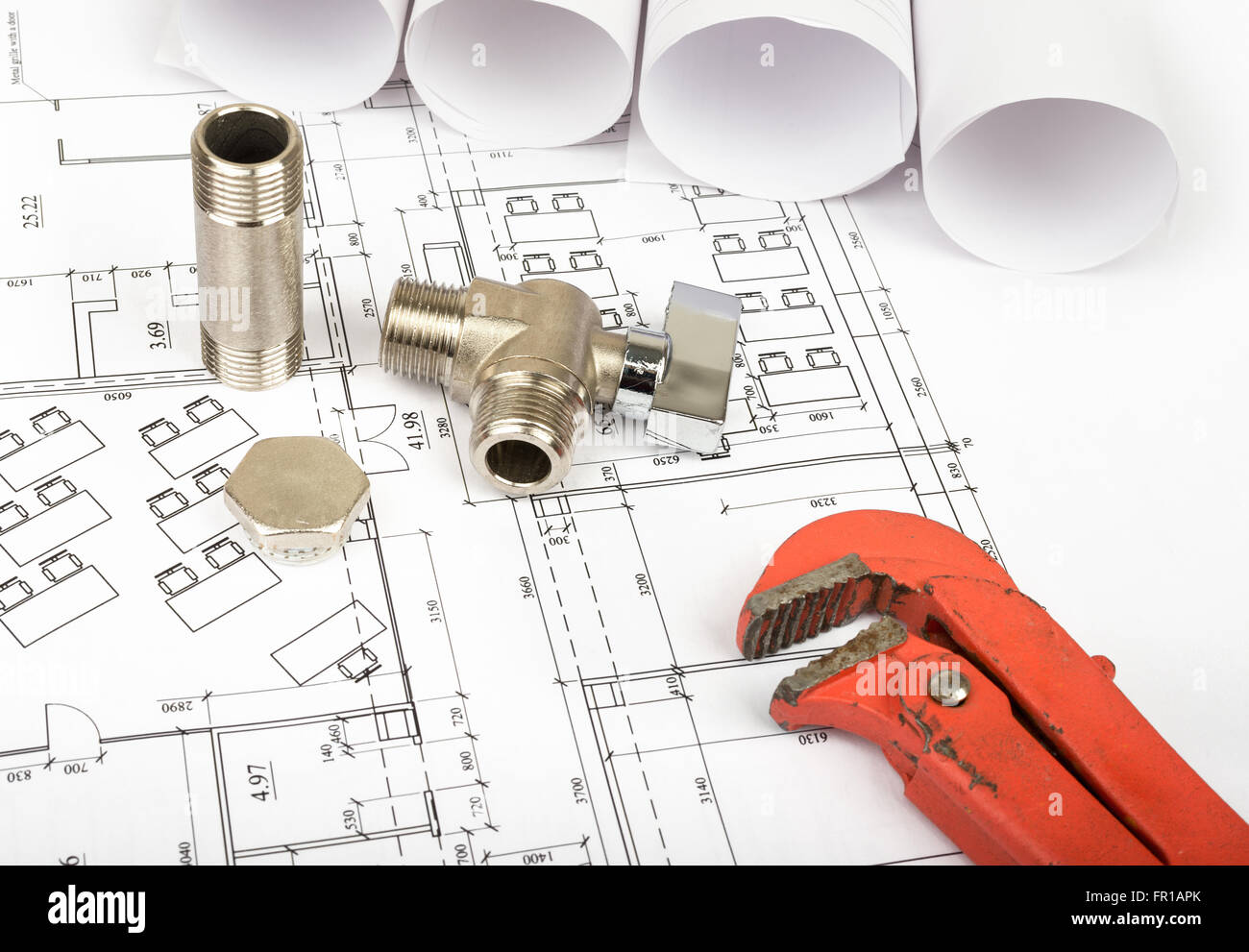 Architecture plan and rolls of blueprints with mixet tap. Building ...