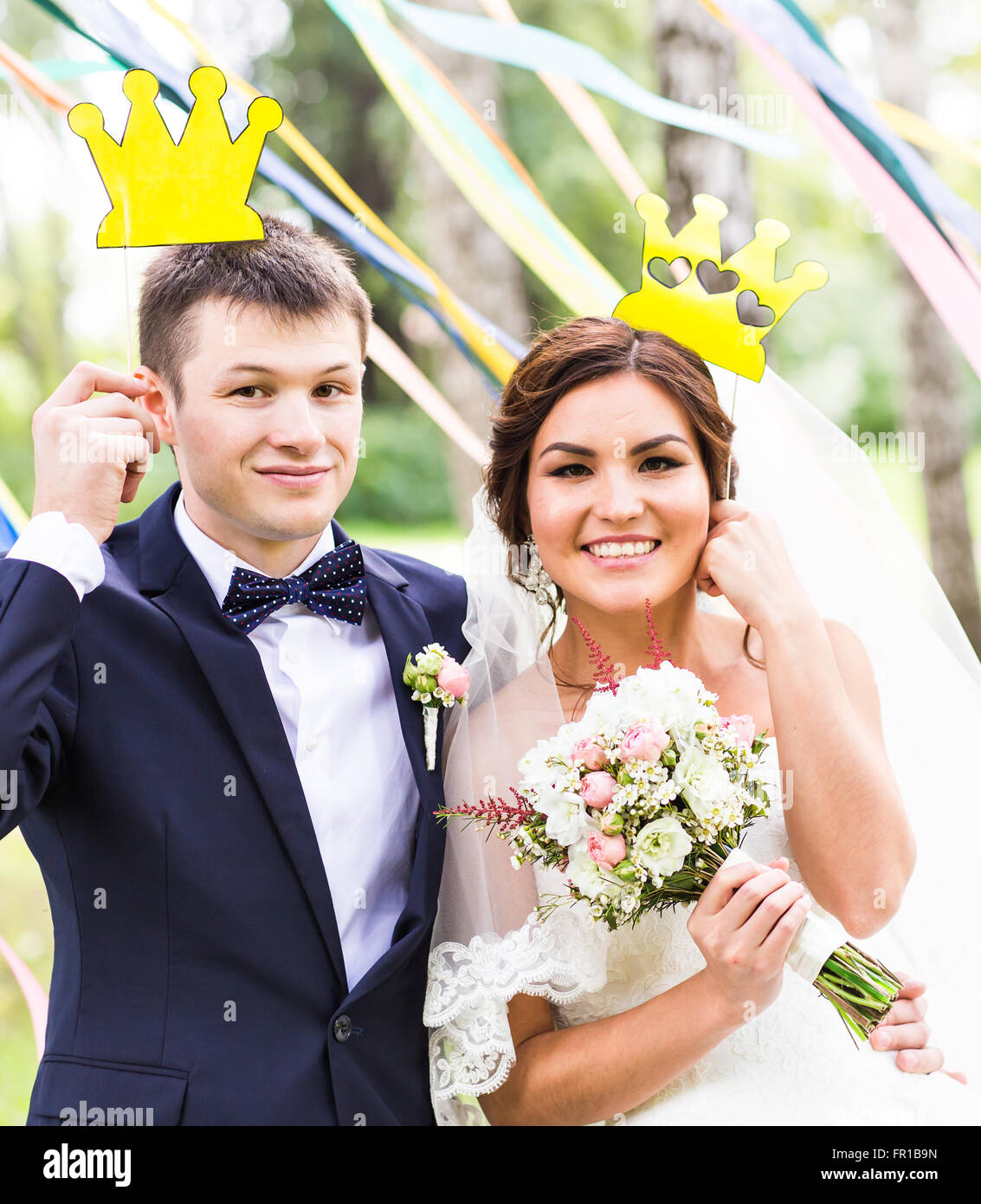 April Fools' Day. Wedding couple posing with crown, mask Stock Photo ...