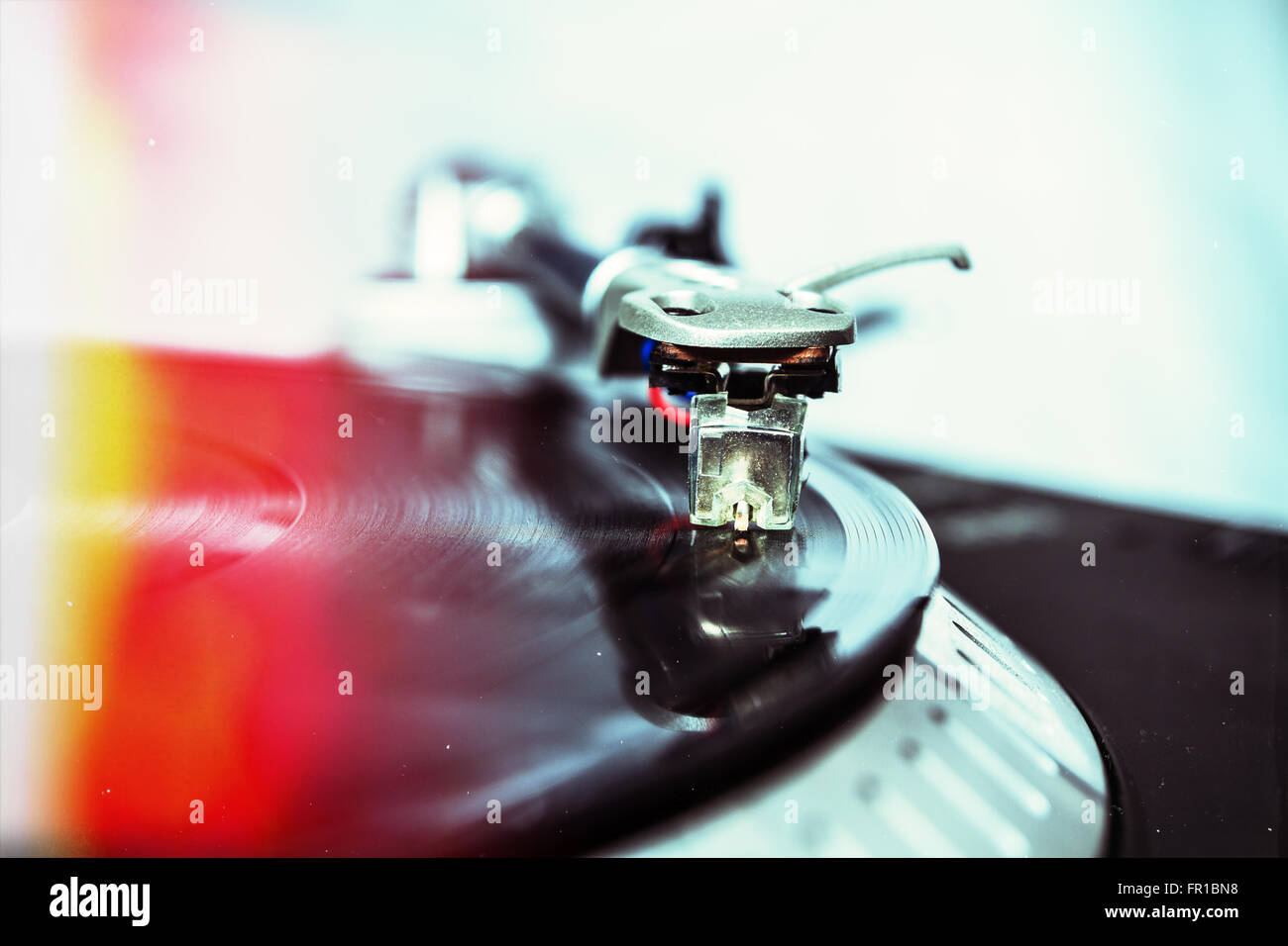 Professional turntable playing vinyl records with music. Close up on ...