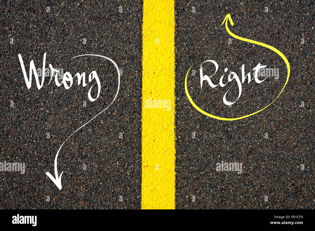 Road marking yellow paint dividing line between Right and Wrong words ...