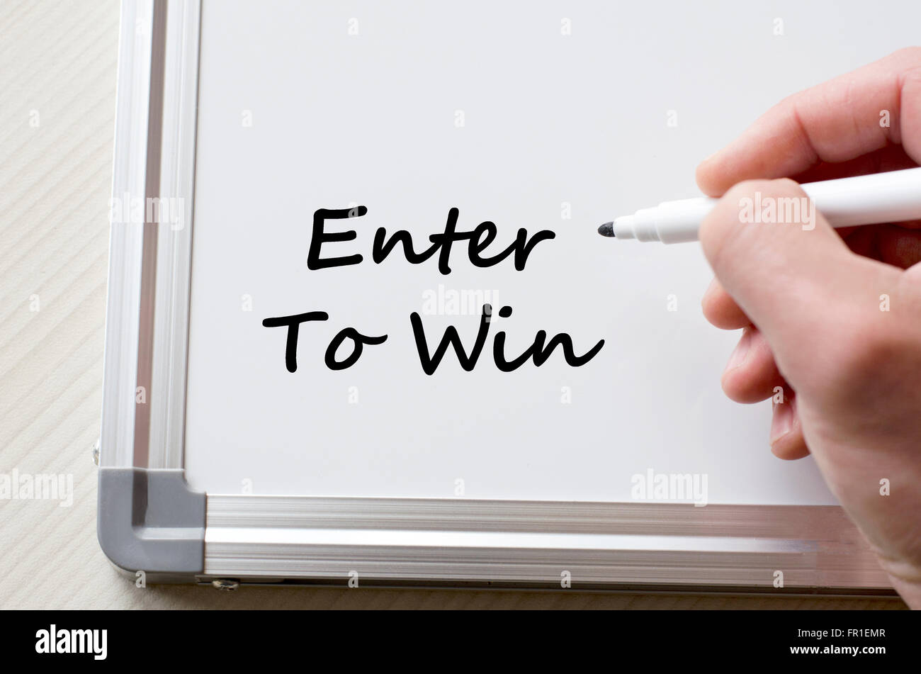 Human hand writing enter to win on whiteboard Stock Photo - Alamy