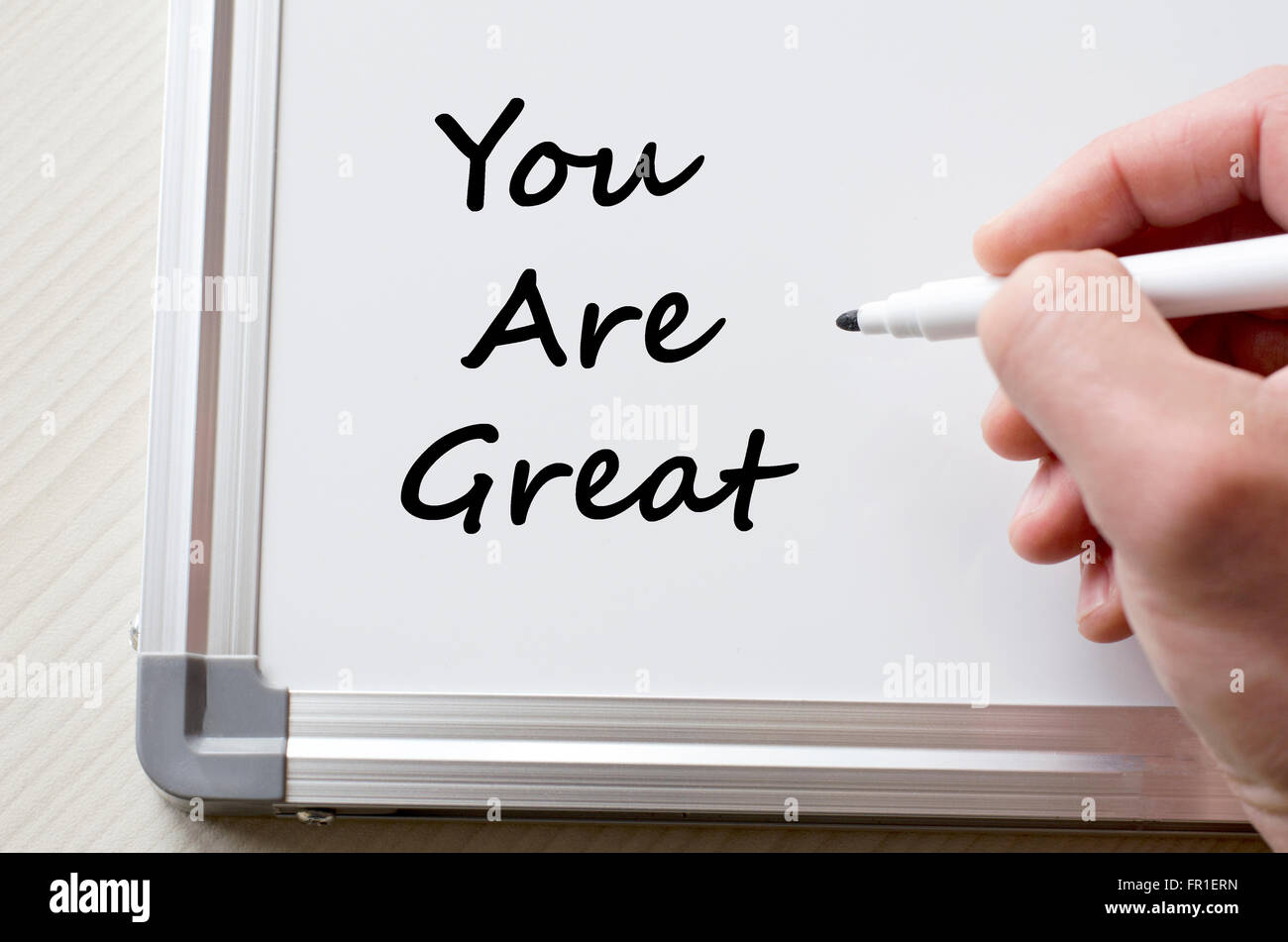 Human hand writing you are great on whiteboard Stock Photo - Alamy