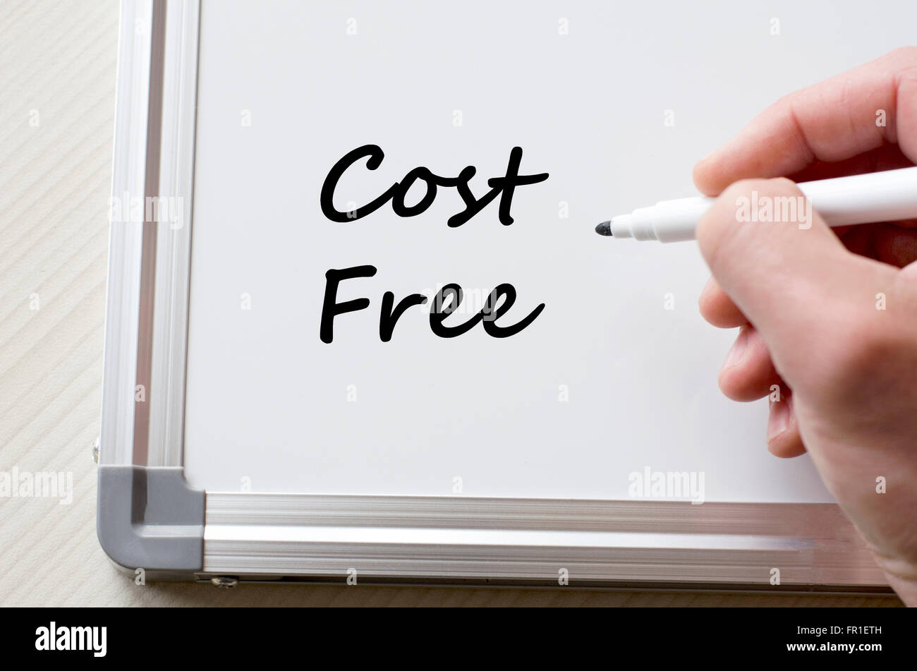 Human hand writing cost free on whiteboard Stock Photo - Alamy