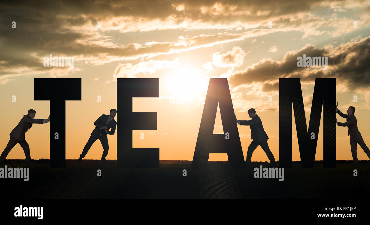 Set of businessmen pushing word team Stock Photo - Alamy