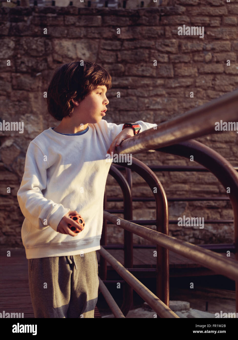Young, elementary age boy playing outdoors ion a playground Stock Photo ...