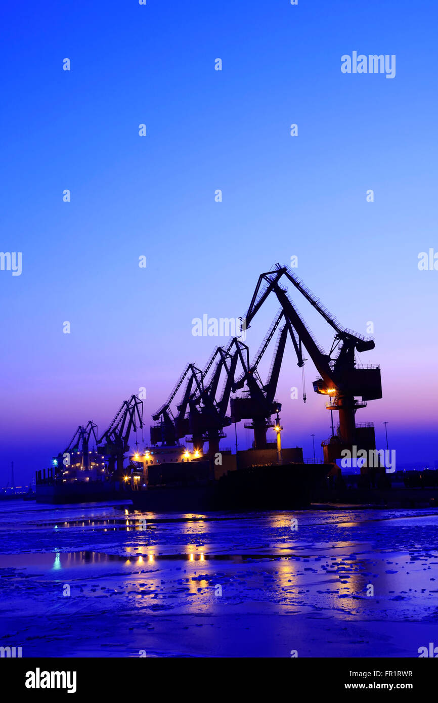 Cargo wharf crane at night Stock Photo - Alamy