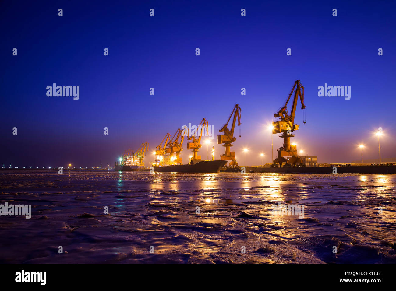 Cargo wharf crane at night Stock Photo - Alamy
