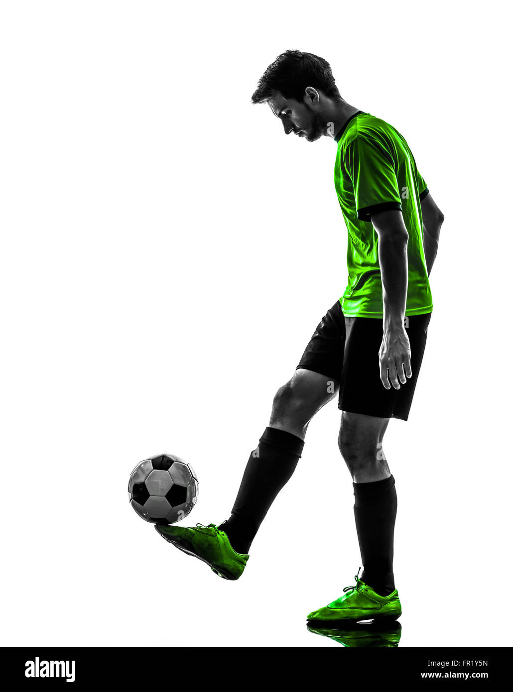 one soccer football player young man juggling in silhouette studio on ...