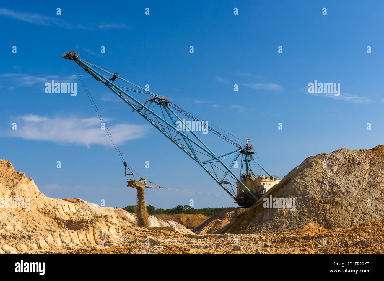 the big dipper dragline excavator digging clay on blue sky background ...