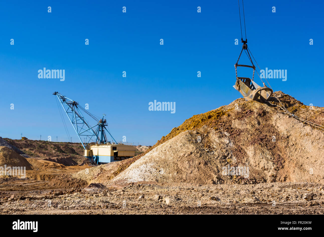 the big dipper dragline excavator digging clay on blue sky background ...