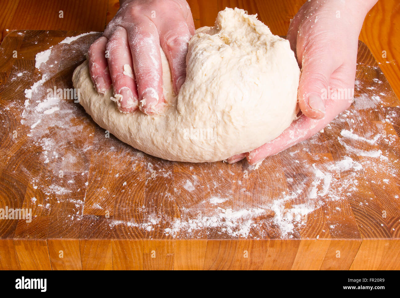 Making dough by female hands on wooden table background Stock Photo - Alamy