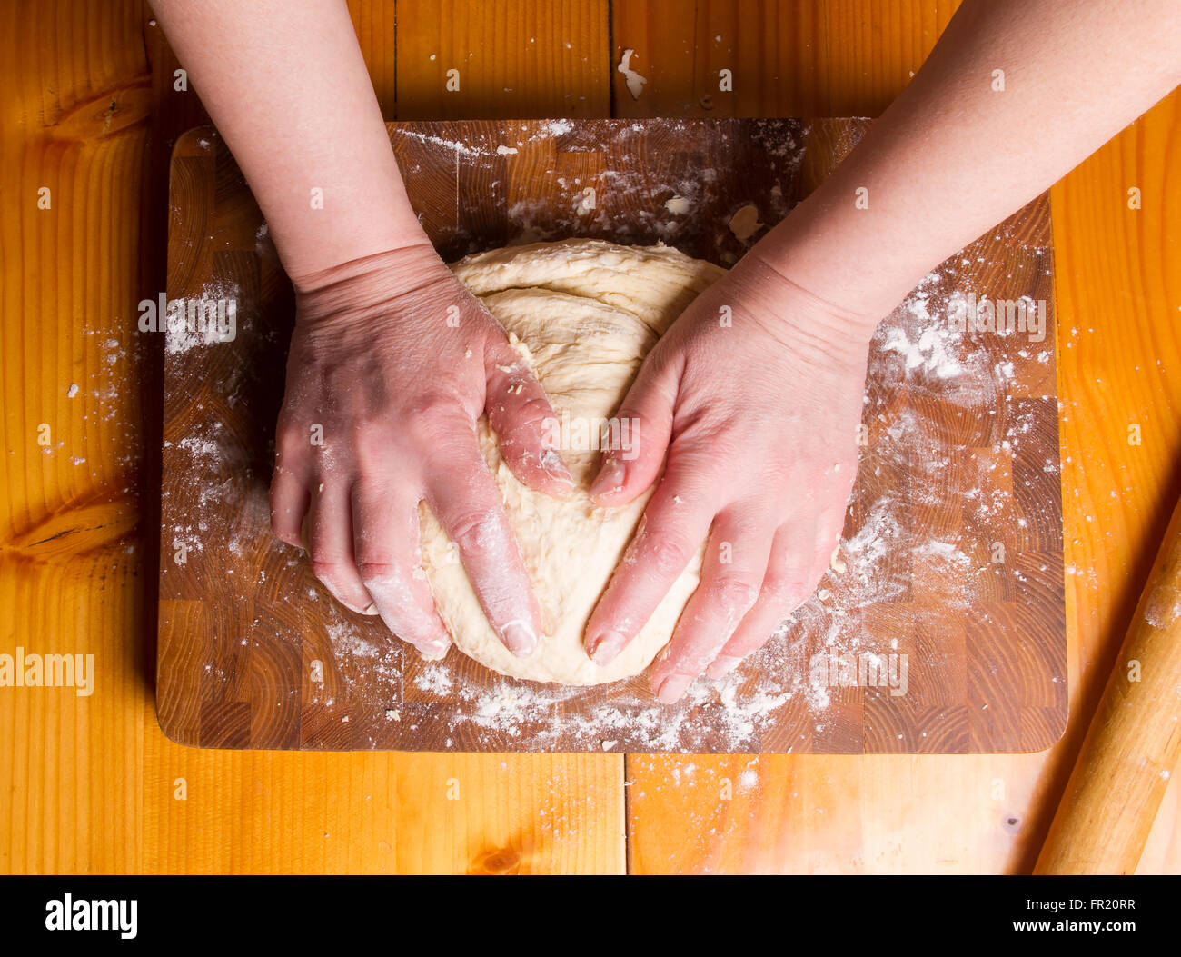 Making dough by female hands on wooden table background Stock Photo - Alamy
