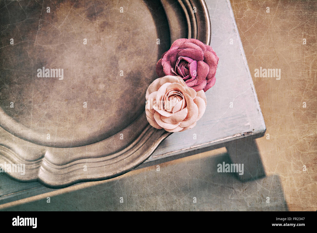 Image of vintage styled flat lay still life with fabric roses on tin ...