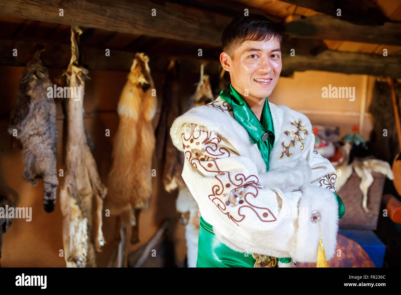 Male hunter in traditional dress at the dwelling Stock Photo - Alamy