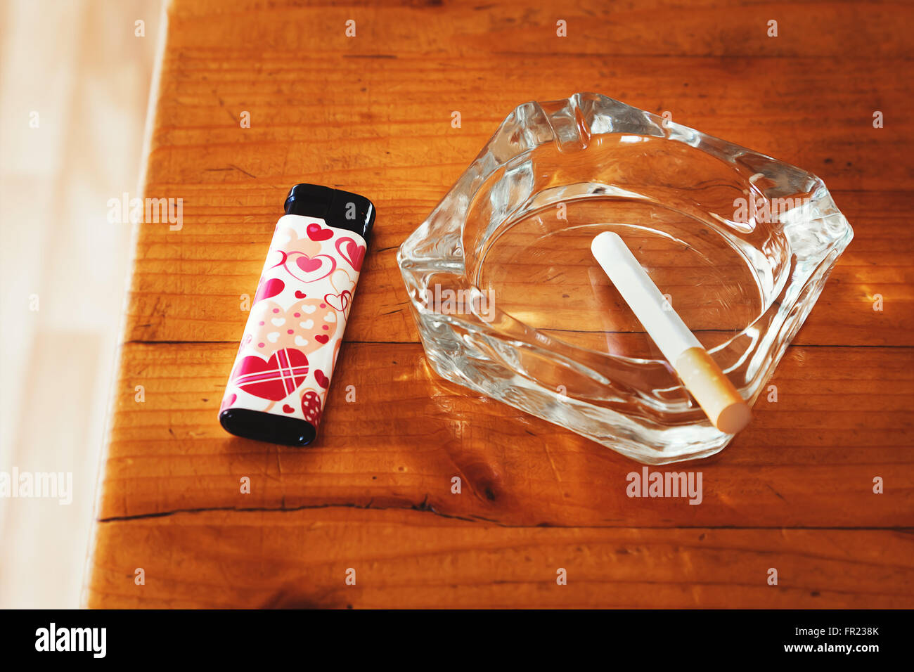cigarette and lighter on a woody table Stock Photo - Alamy