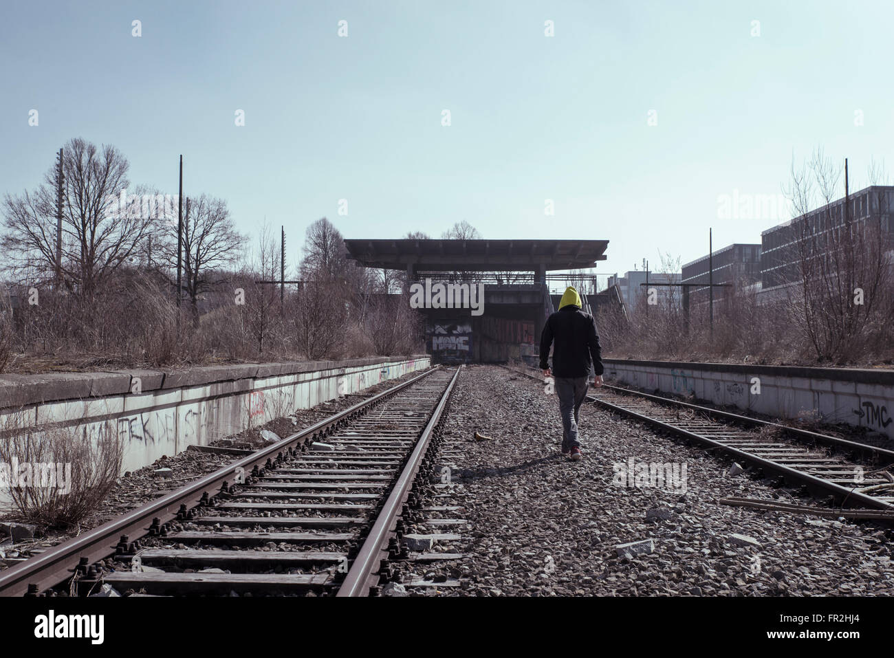 man walking on rails at olympic trains station Stock Photo - Alamy