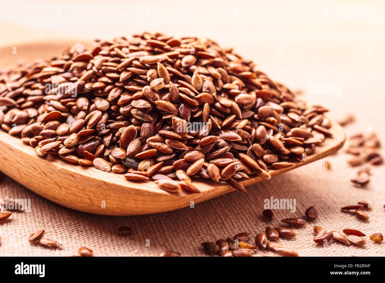 Healthy food for preventing heart diseases and overweight. Flax seeds linseed on wooden spoon ...