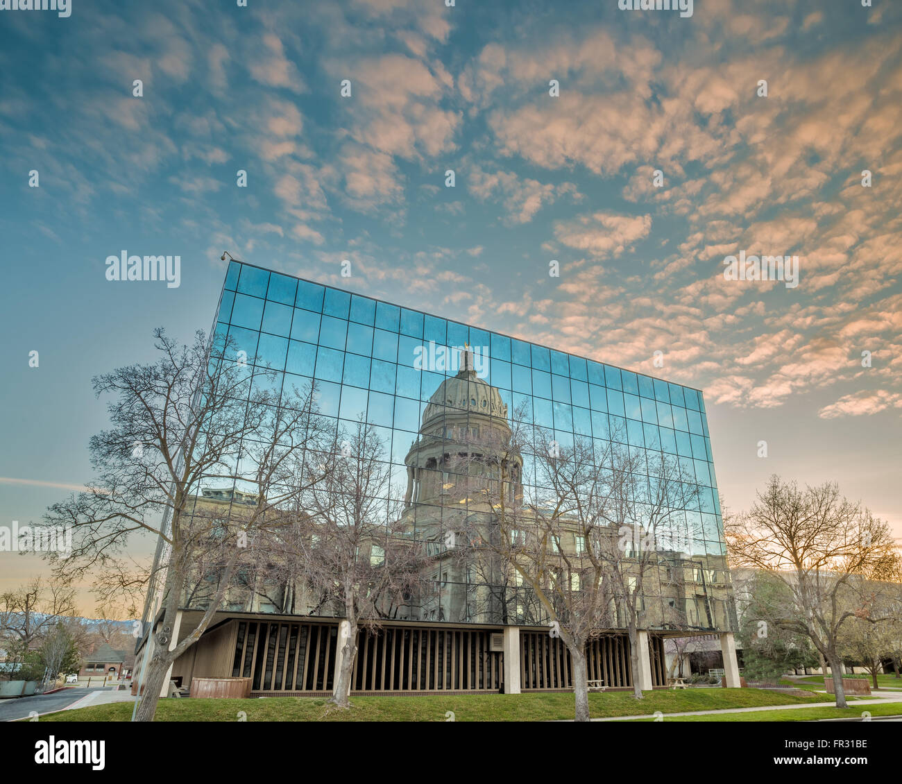 Reflection of the Idaho state capitol building with morning clouds ...