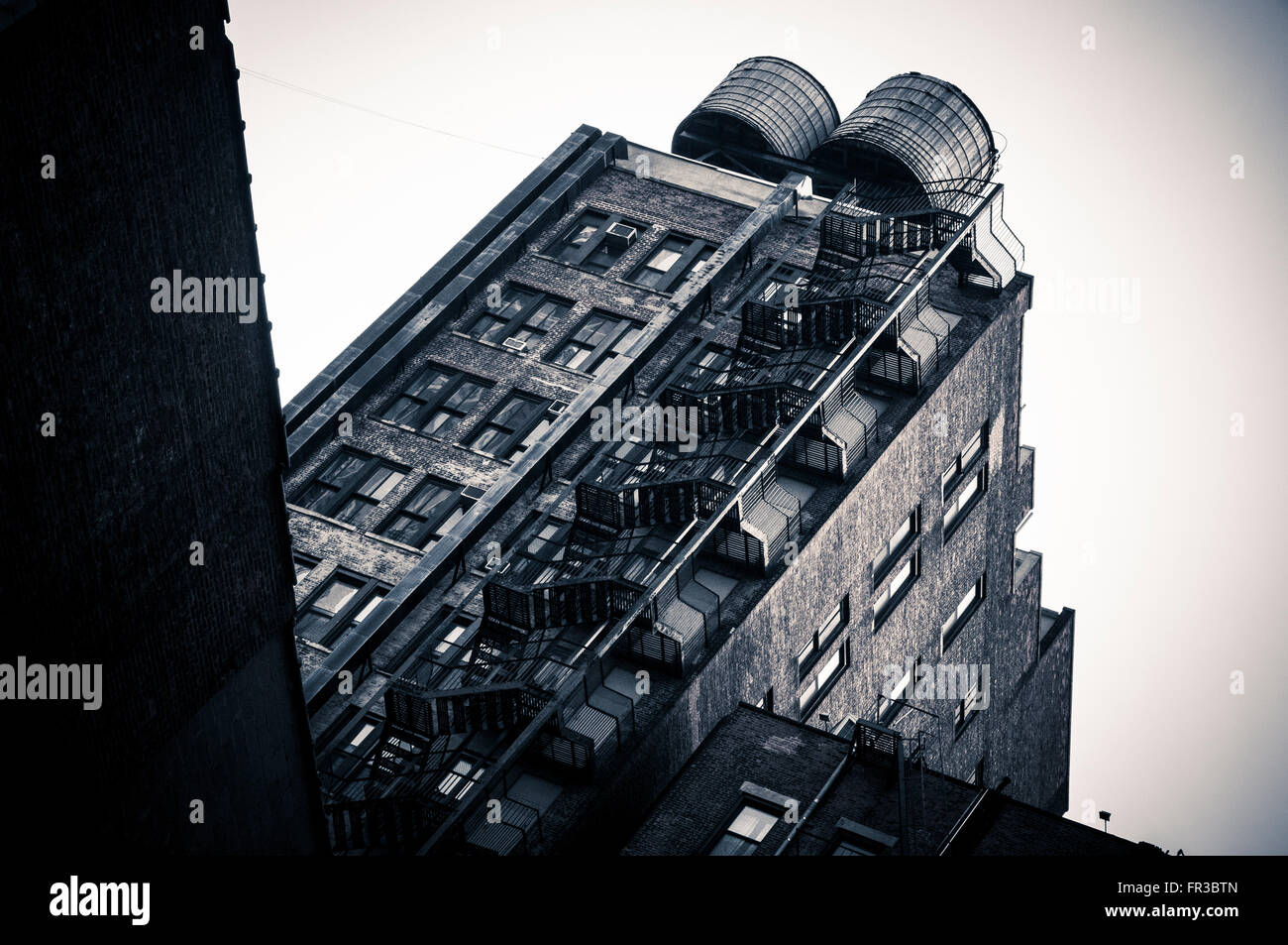 Traditional New York City brick building with wooden water towers on ...