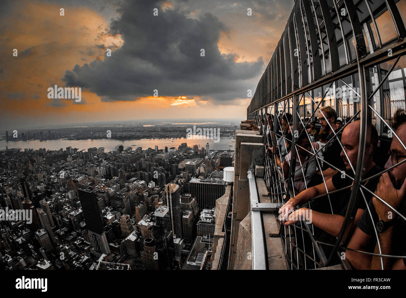 Tourists at the top of the Empire state Building looking out over ... Tourists at the top of the Empire state Building looking out over ...