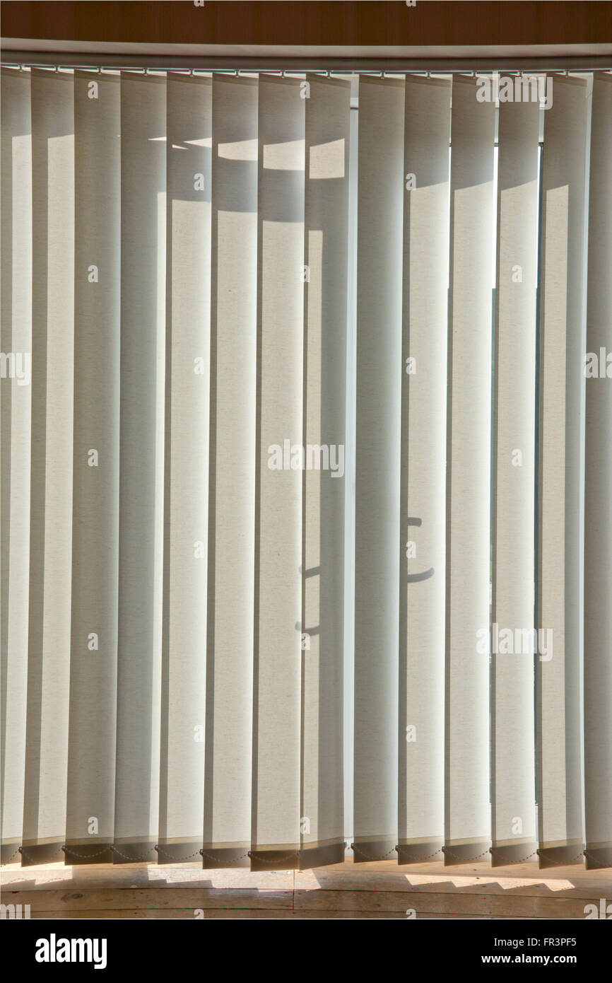 Sun shining through vertical blinds Stock Photo - Alamy