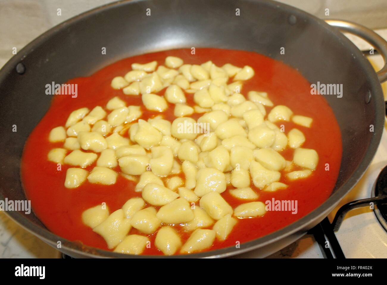 traditional italian gnocchi cooked with tomato sauce Stock Photo - Alamy