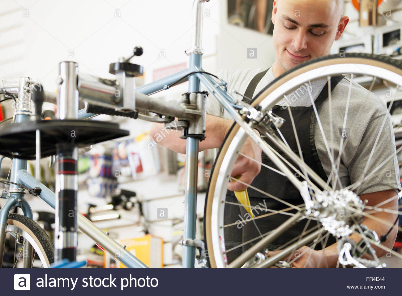 man repairing bike at bike shop Stock Photo - Alamy