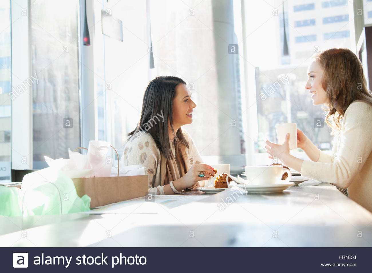 stylish young women having coffee Stock Photo - Alamy