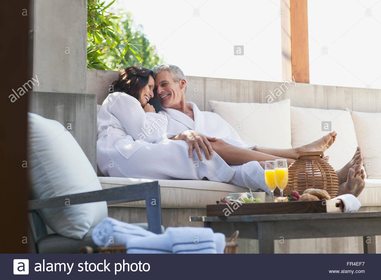 couple cuddling on outdoor patio Stock Photo - Alamy