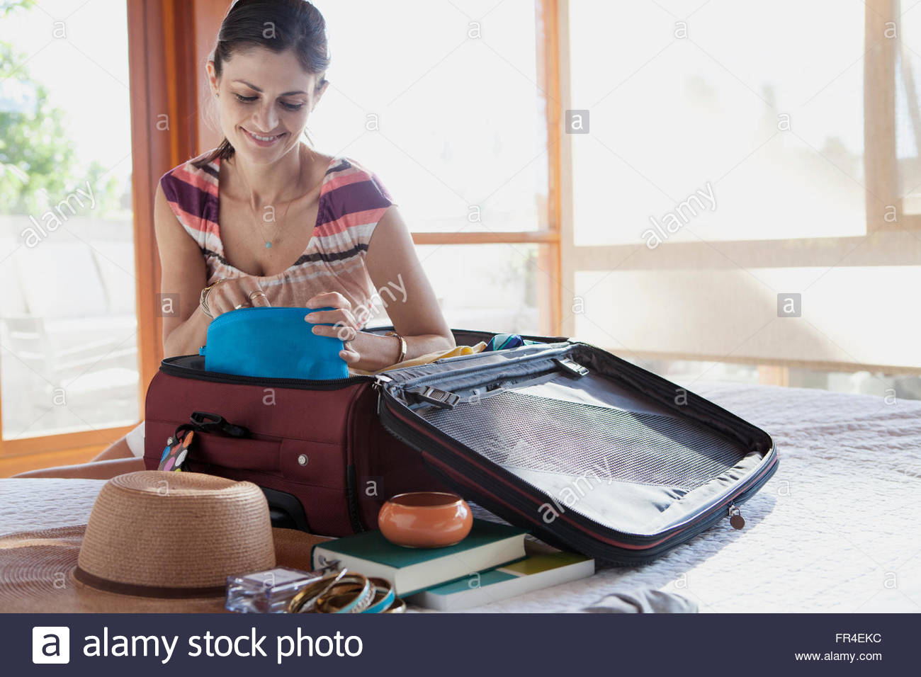 Woman packing suitcase holiday hi-res stock photography and images - Alamy