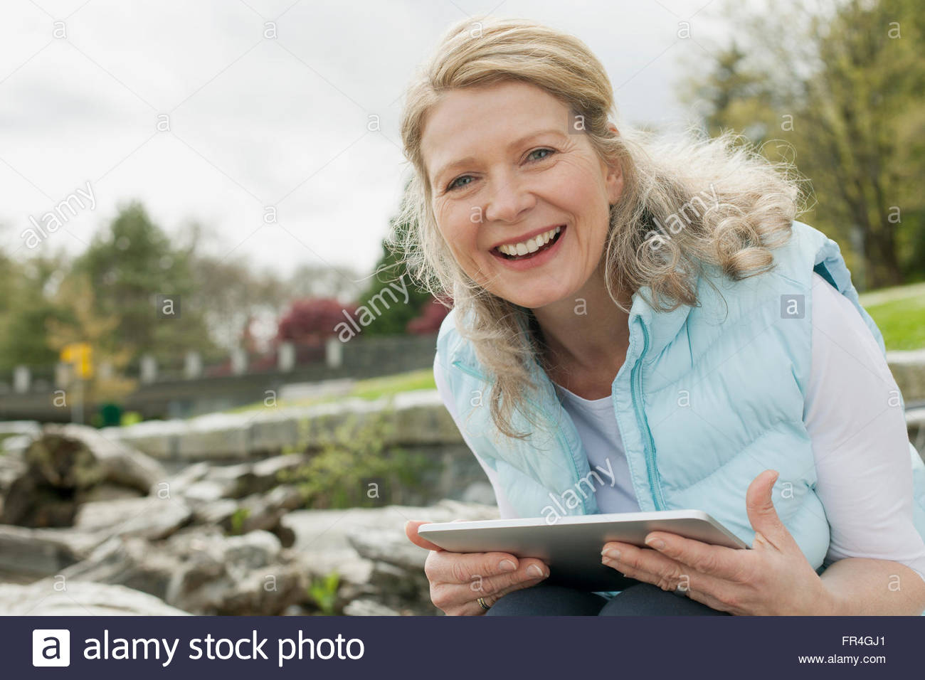 Portrait of pretty boomer using pc tablet outdoors Stock Photo - Alamy