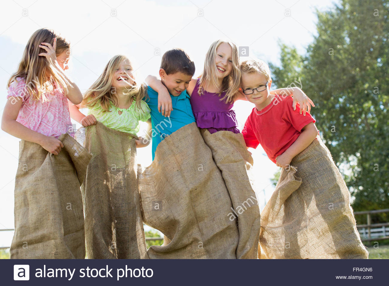 Cousins getting ready for potato sack race Stock Photo - Alamy
