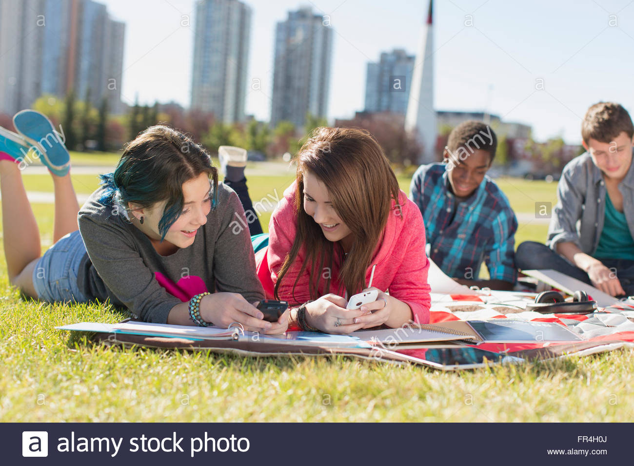 teenagers doing homework in outdoor park Stock Photo - Alamy