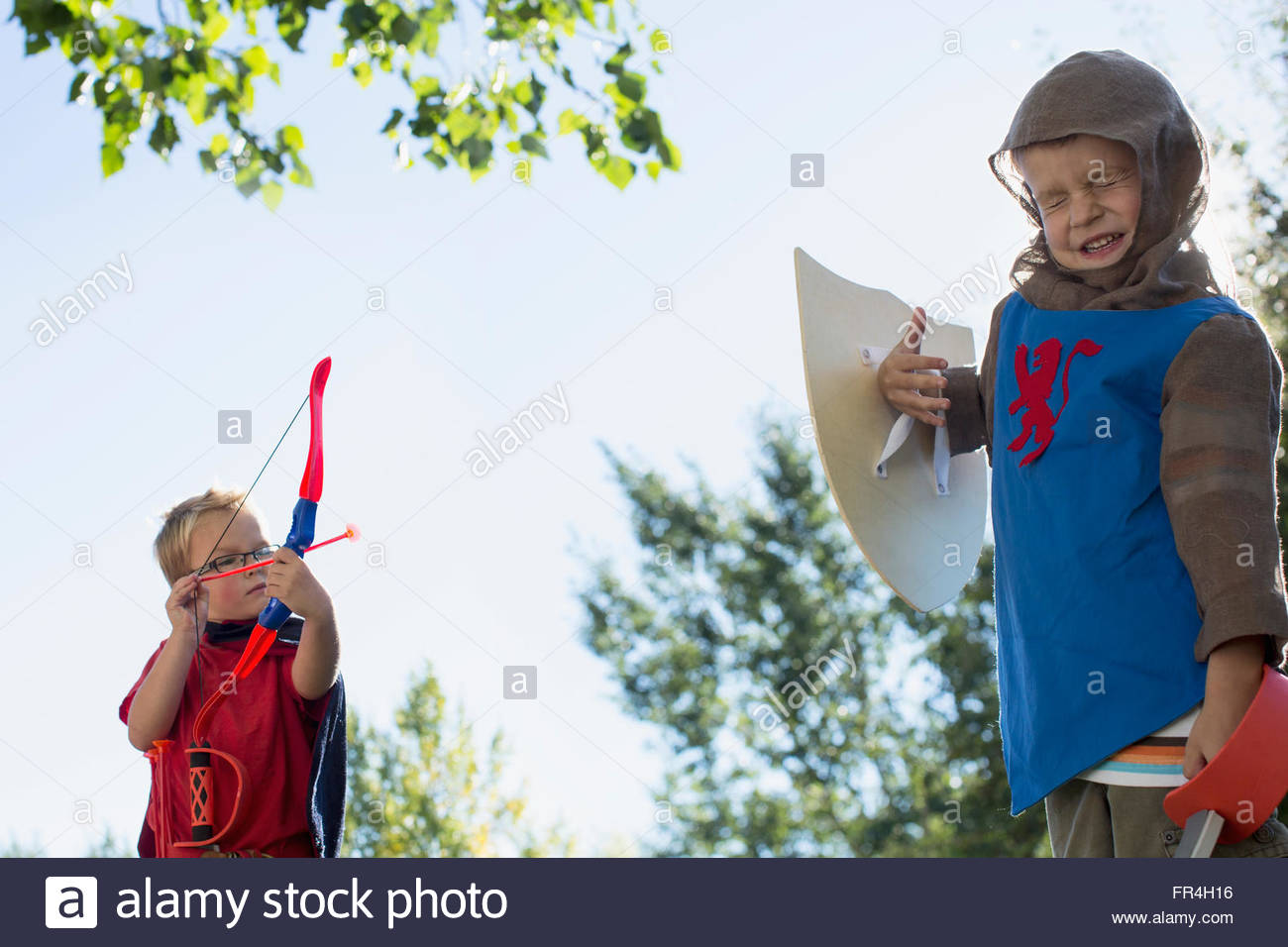 Young boys play fighting in costumes Stock Photo - Alamy