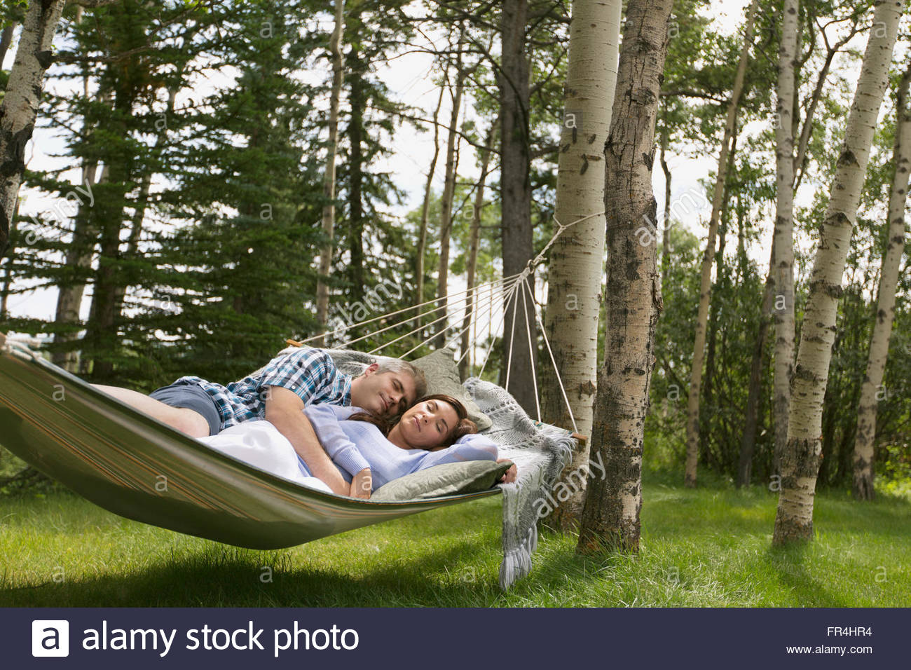 couple napping together in hammock Stock Photo - Alamy