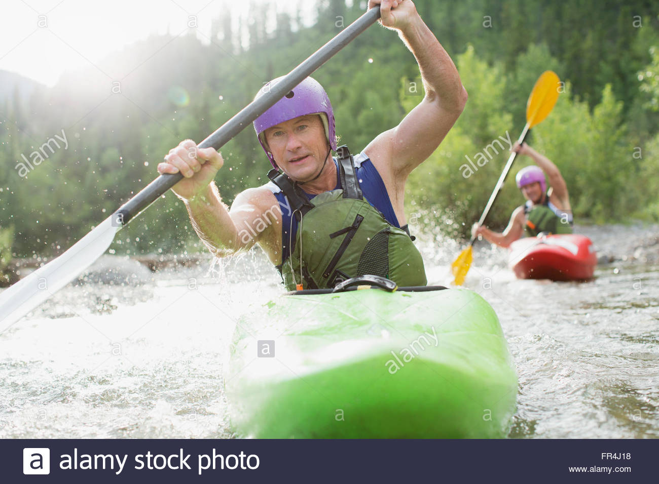 two male kayakers paddling down the river Stock Photo - Alamy