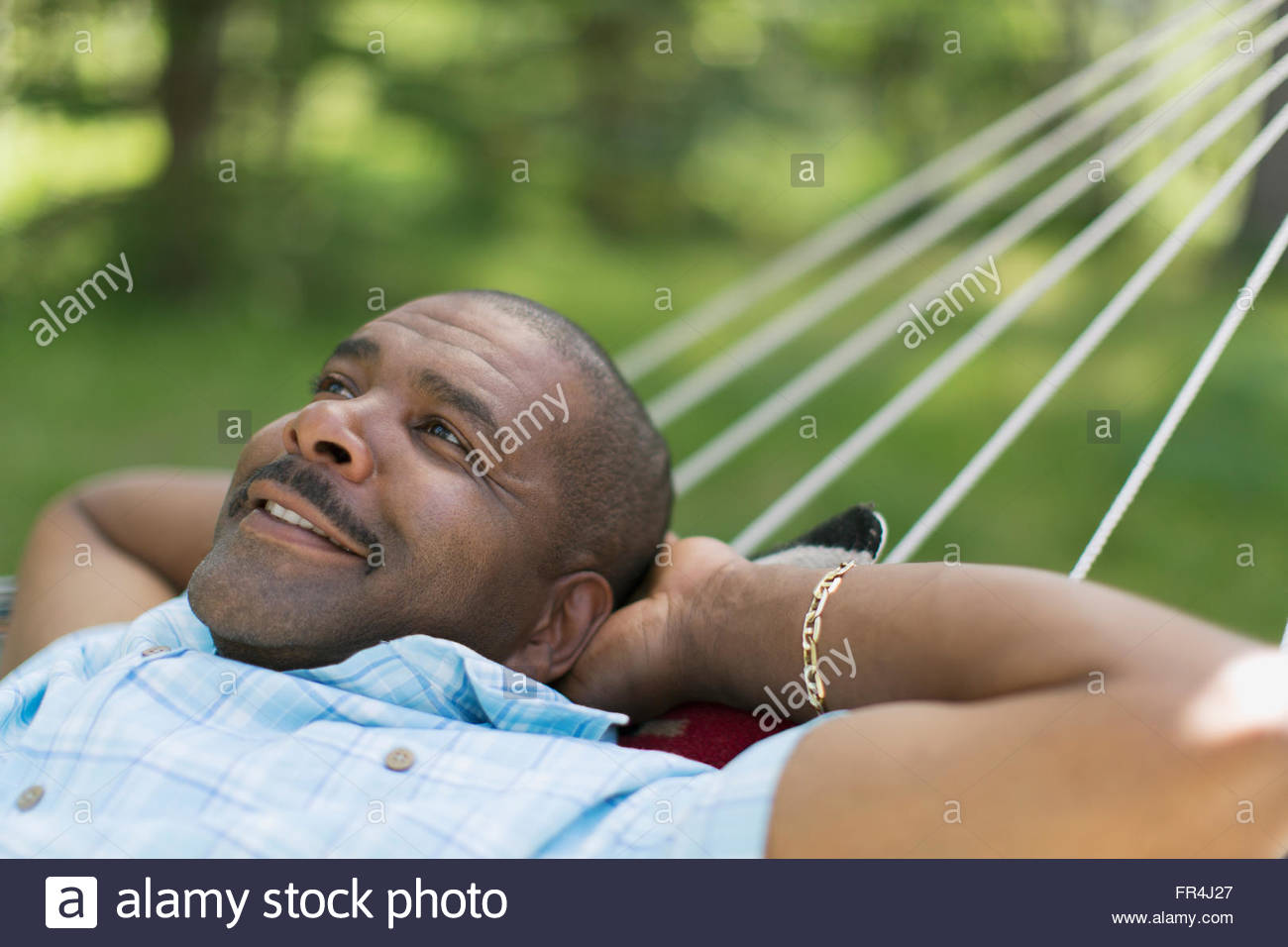 african american man relaxing in hammock Stock Photo - Alamy