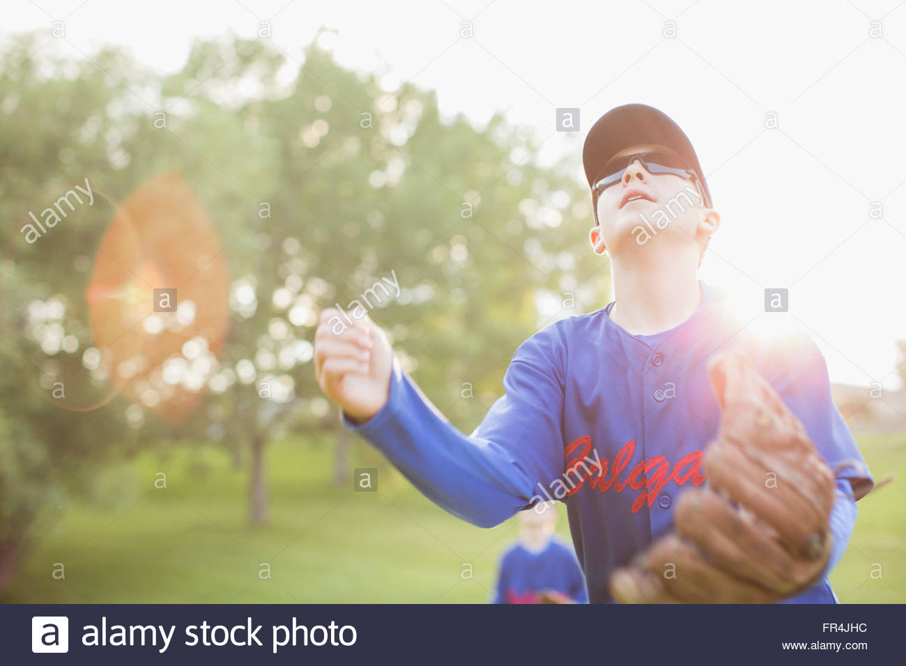 Young baseball player looking up for fly ball Stock Photo - Alamy