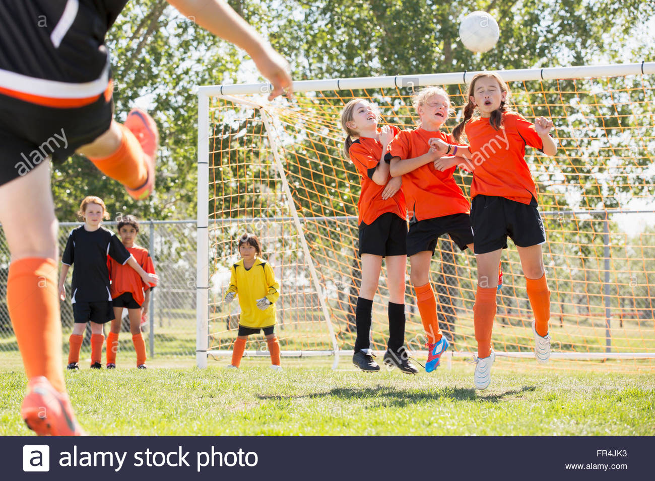 Young soccer player defending her net with a header Stock Photo - Alamy