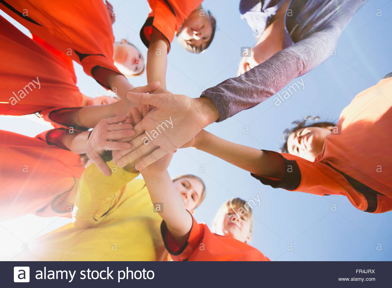 Team huddle hands children hi-res stock photography and images - Alamy