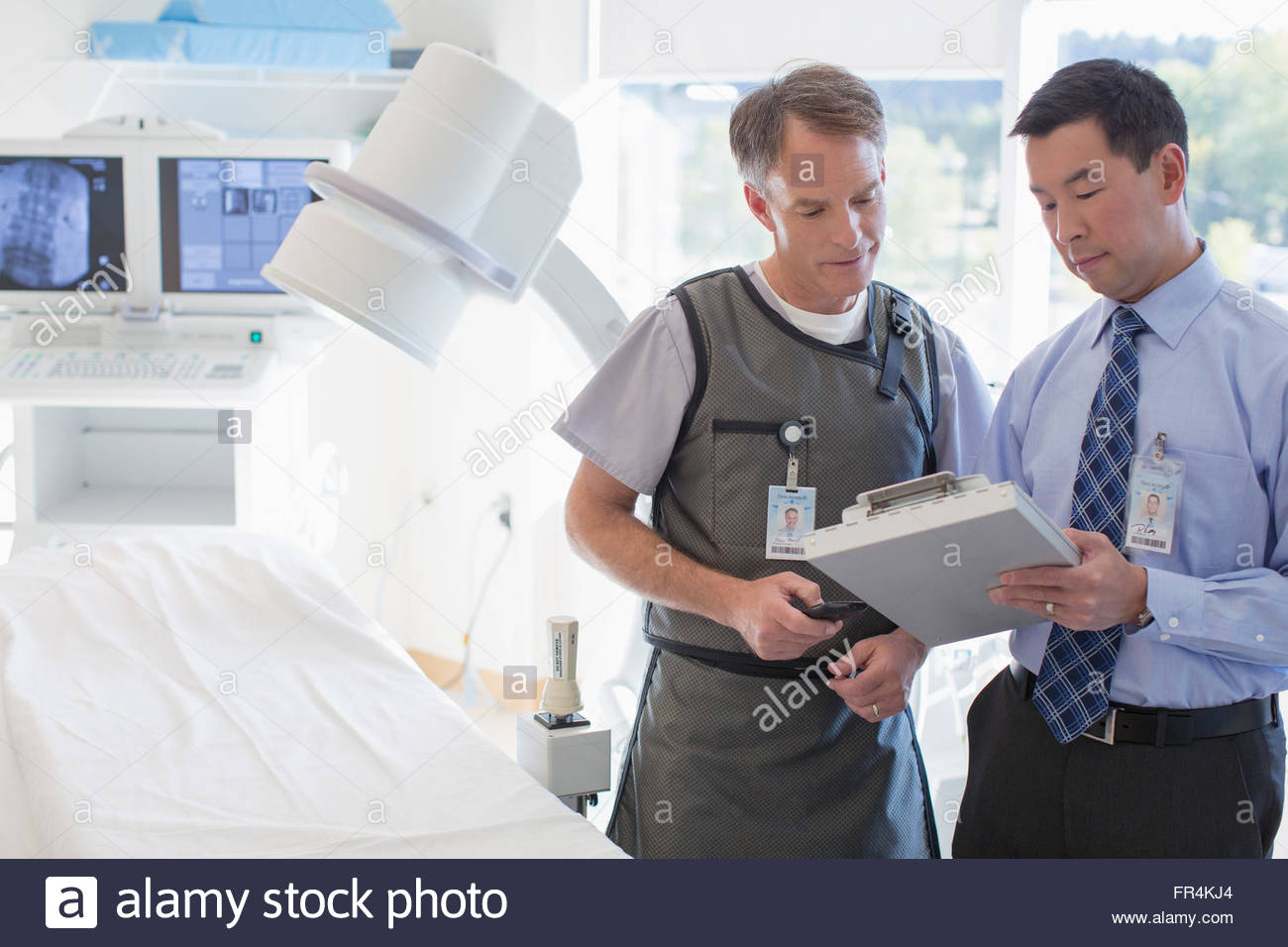 radiology technician and doctor reviewing medical chart together Stock ...