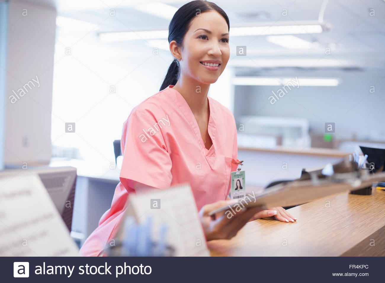 nurse holding medical chart at nursing station Stock Photo - Alamy
