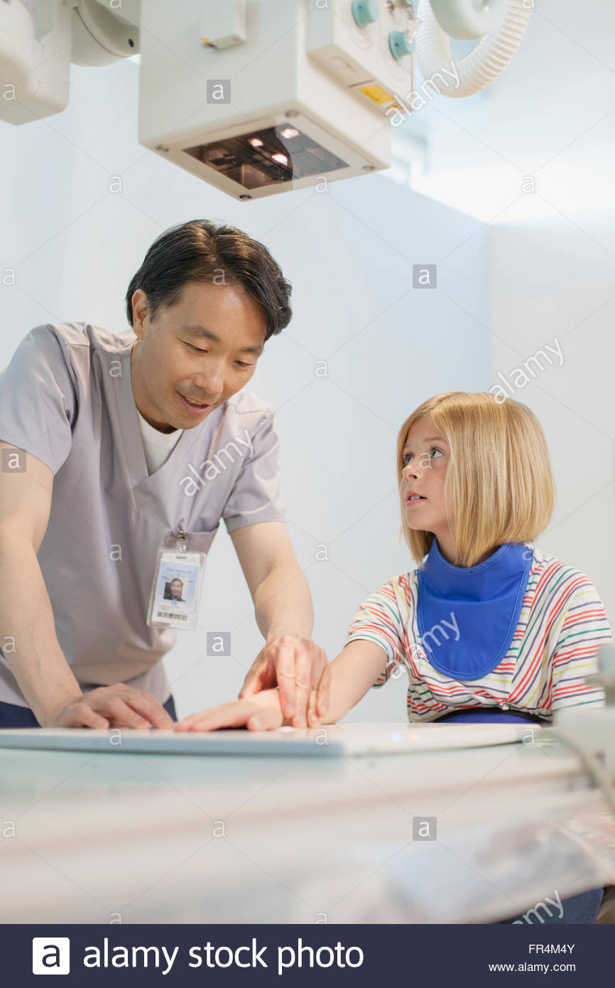 x-ray technician adjusting position of young patients hand Stock Photo ...