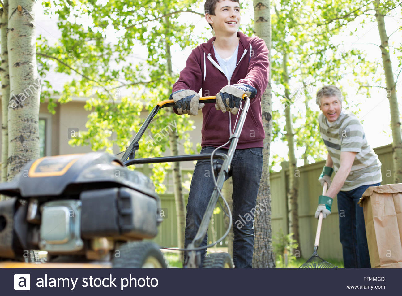 teenage son and father doing yardwork Stock Photo - Alamy