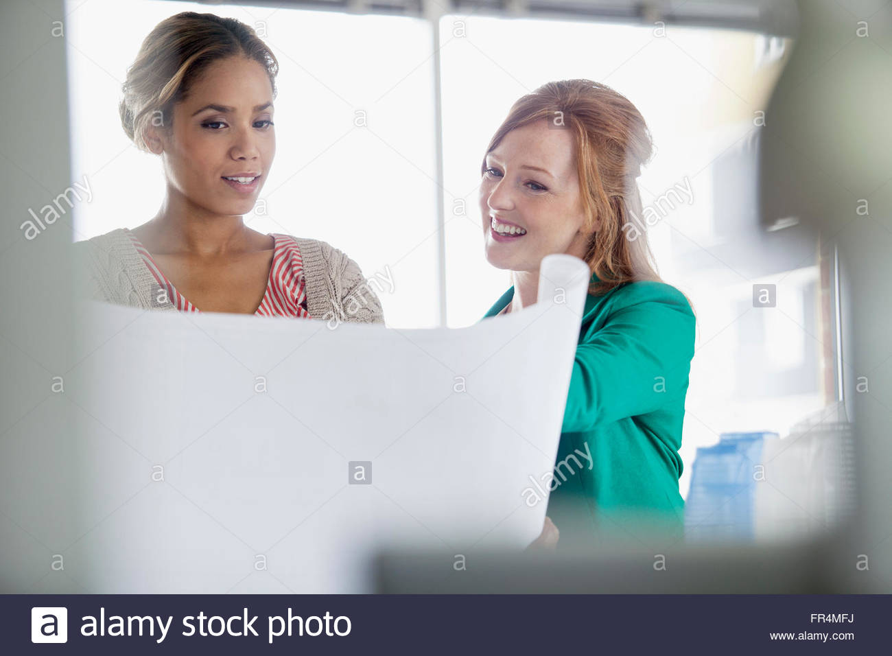 female office workers reviewing plans together Stock Photo - Alamy female office workers reviewing plans together Stock Photo - Alamy