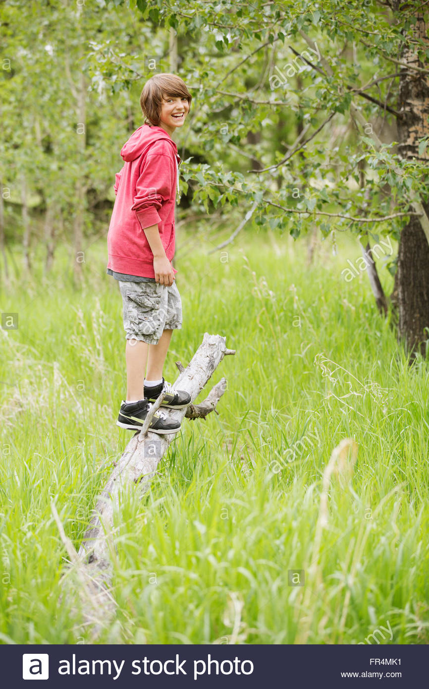 middle school student standing on fallen tree branch Stock Photo - Alamy